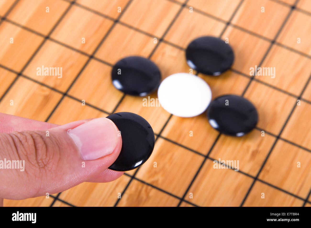 Close up view of hand playing black and white stone pieces on Chinese ...