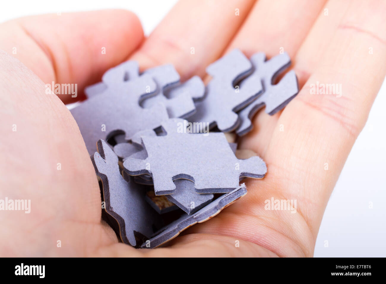 Some little puzzle pieces in hand palm on white Stock Photo - Alamy