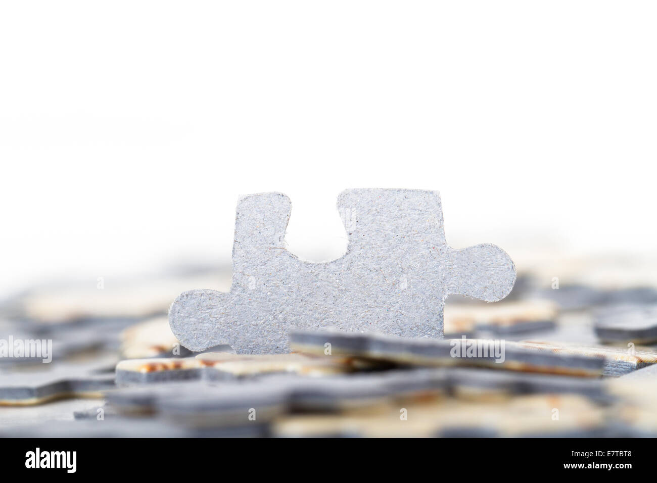 Small puzzle piece standing out among others, isolated on white ...