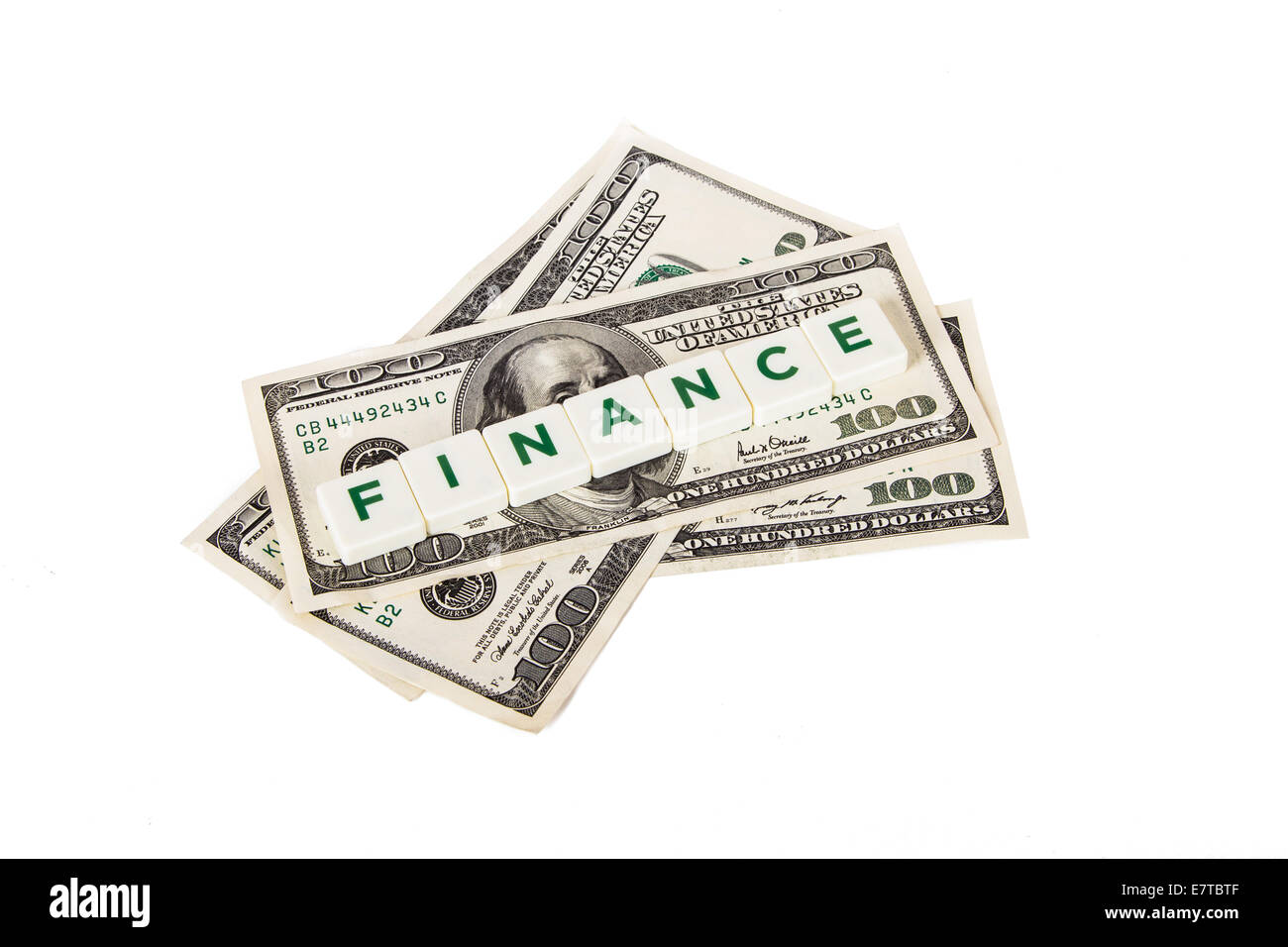Finance word in letters and one hundred dollar bills, isolated on white ...