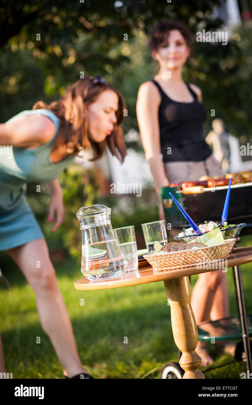 Two pretty girls making food on grill Stock Photo - Alamy
