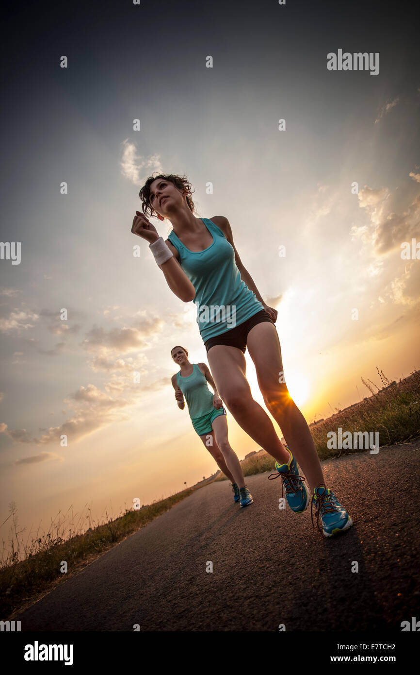 Two pretty girls jogging in the morning Stock Photo - Alamy