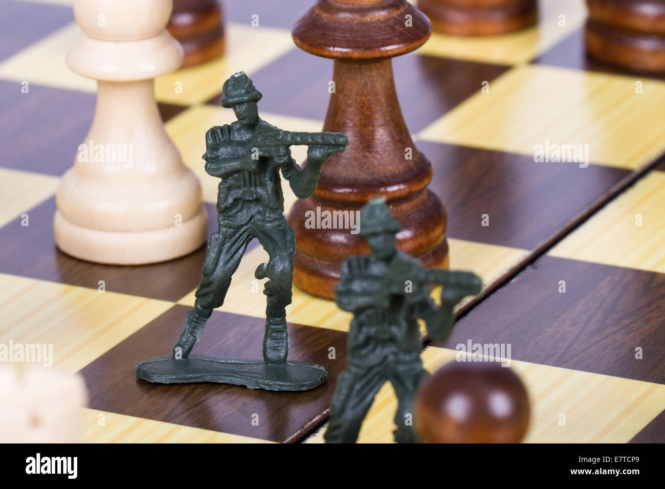 Close up view of miniature toy soldiers on chess board Stock Photo - Alamy