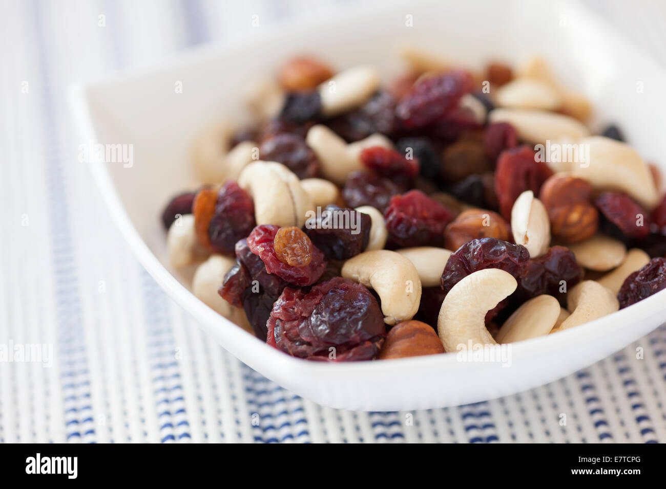 Dried nuts and berries mix in a bowl Stock Photo - Alamy
