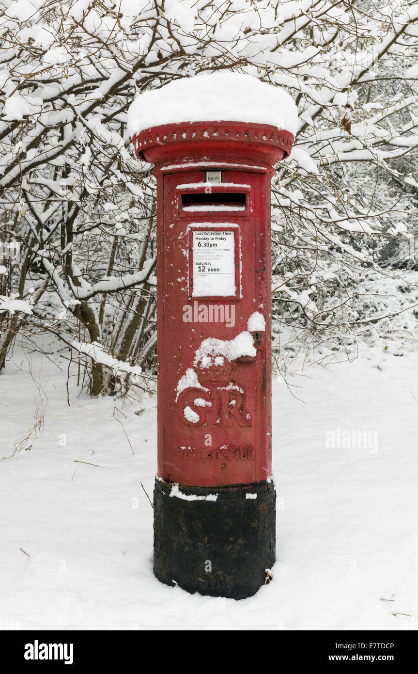 Snow topped traditional Georgian red British post box Stock Photo - Alamy