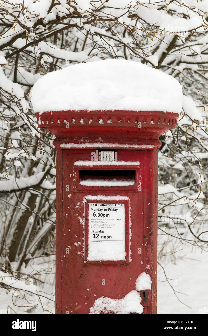Snow topped traditional Georgian red British post box Stock Photo - Alamy