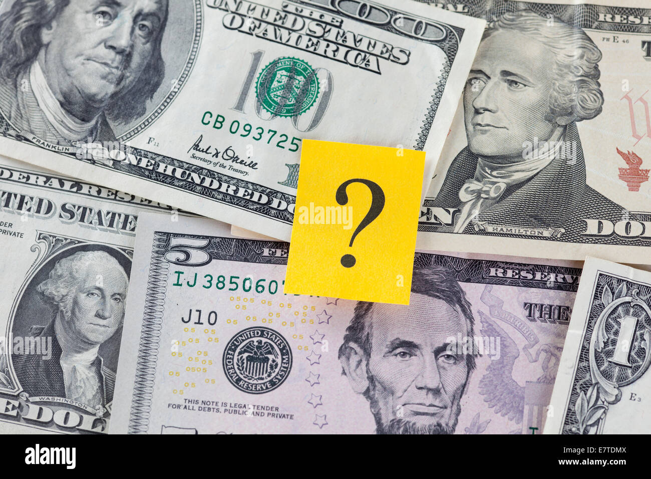 Question mark on Dollar Bills Stock Photo - Alamy