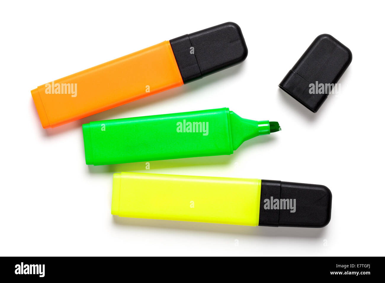 Highlighters on white background. Yellow, orange and green. Top view ...