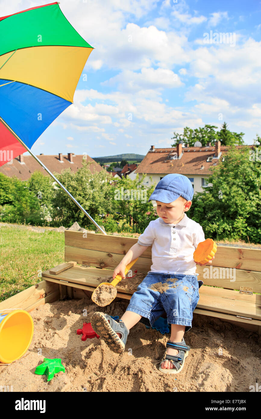 little male child playing in the sandbox Stock Photo - Alamy
