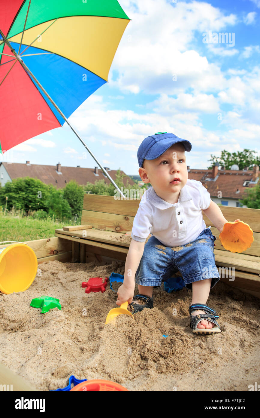 little male child playing in the sandbox Stock Photo - Alamy