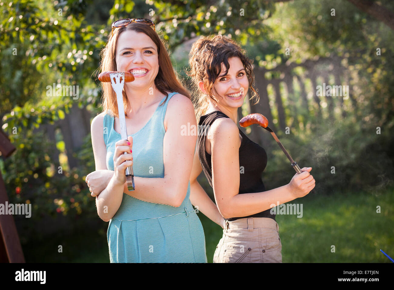 Two pretty girls making food on grill Stock Photo - Alamy