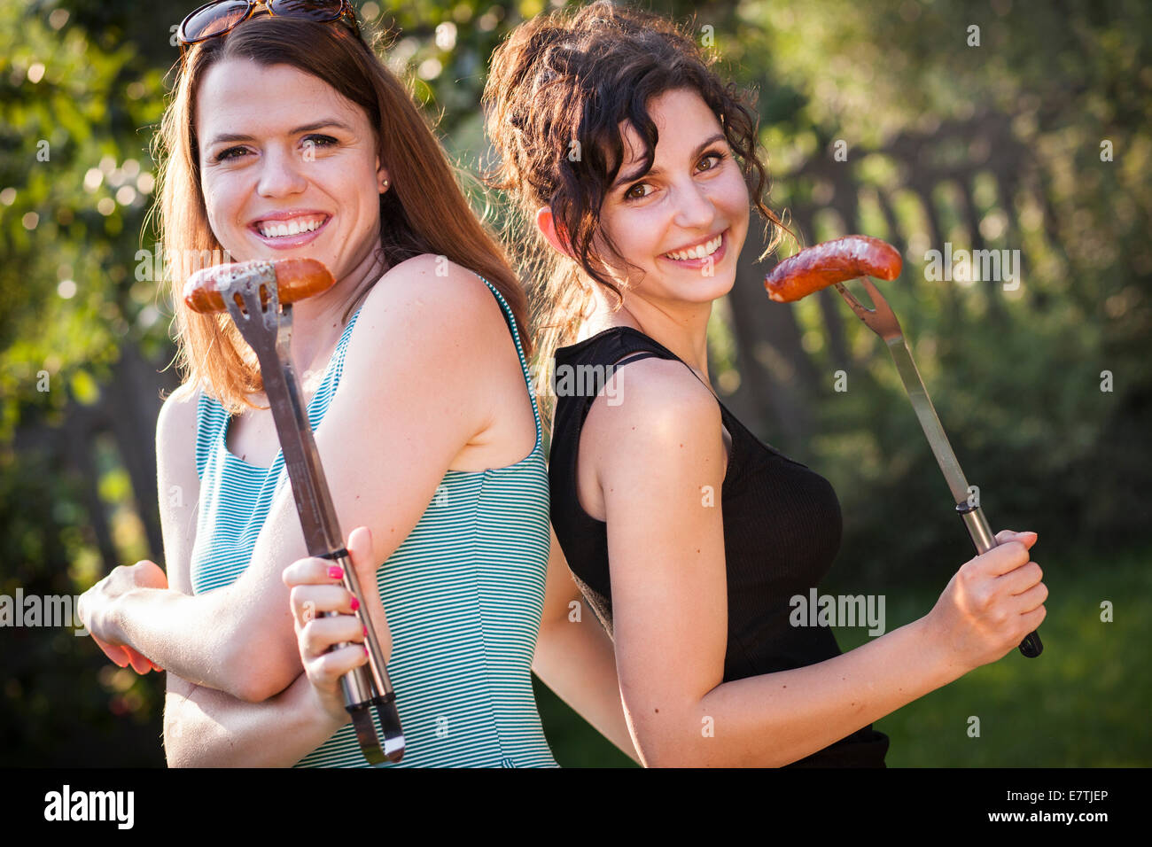 Two pretty girls making food on grill Stock Photo - Alamy