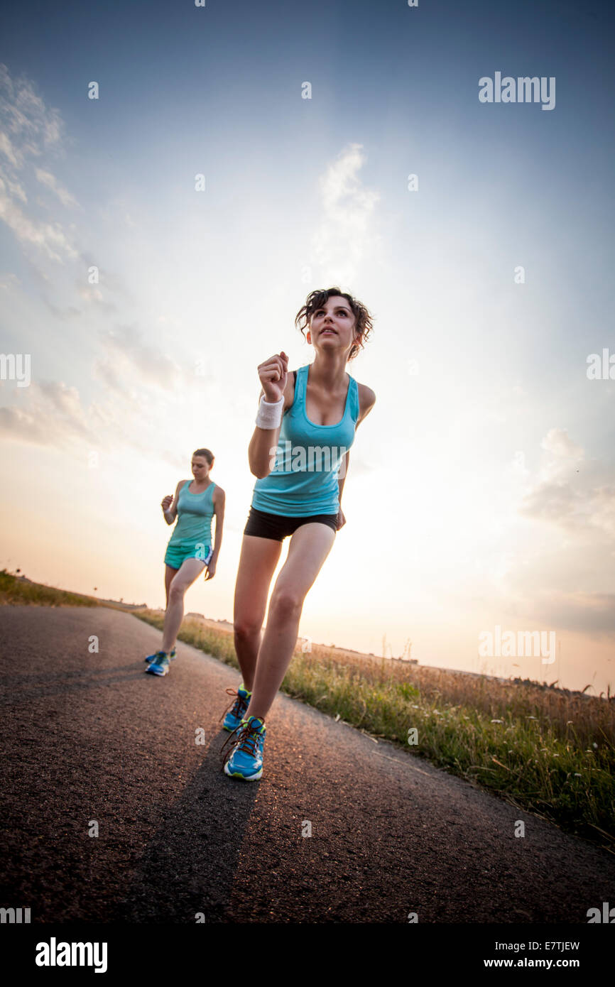Two pretty girls jogging in the morning Stock Photo - Alamy