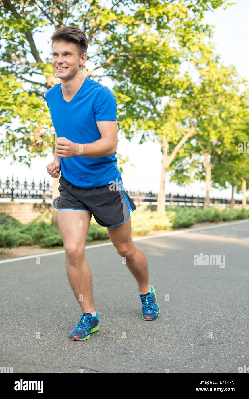Young man running in park Stock Photo - Alamy