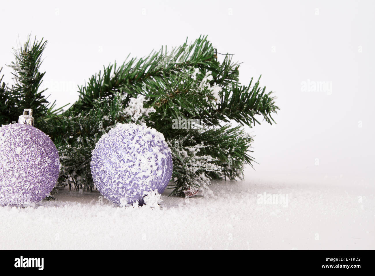 Snowy christmas decoration objects with ornaments and balls on white ...