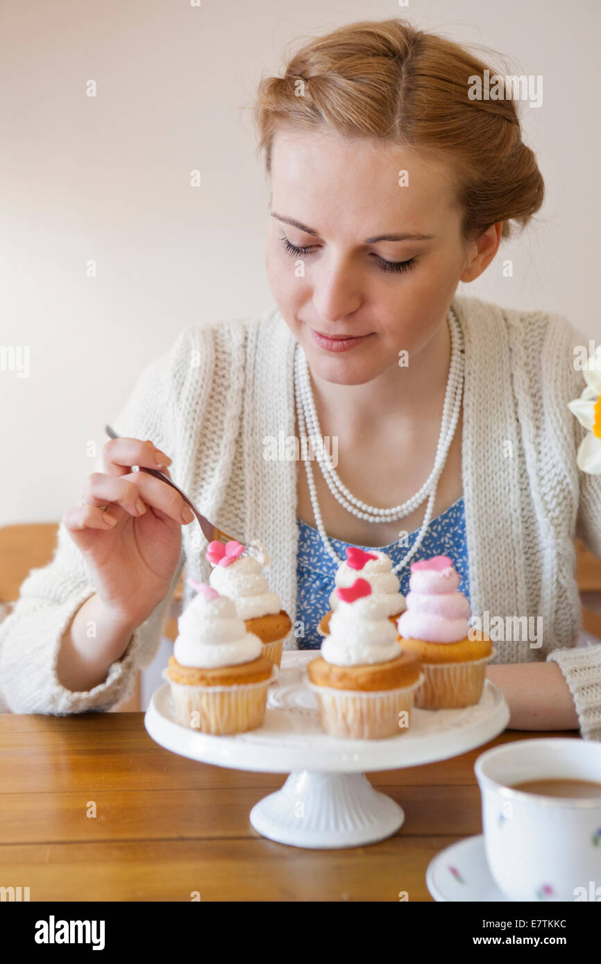 Vintage style portrait of a woman with cupcakes Stock Photo - Alamy