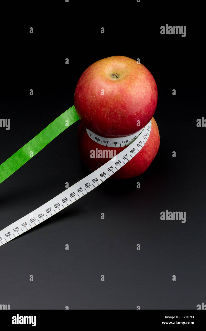 Home grown apples with meter ribbon on dark background Stock Photo - Alamy