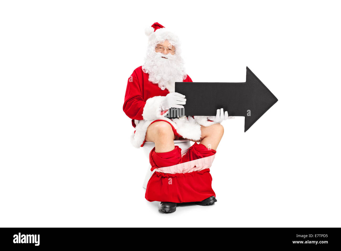 Santa Claus holding a big black arrow seated on a toilet isolated on ...