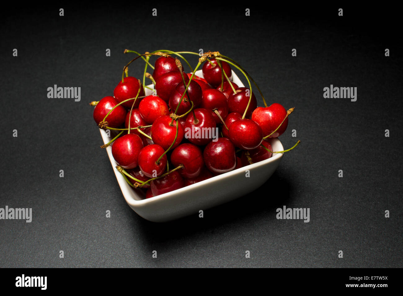 Cherries on dark background Stock Photo - Alamy