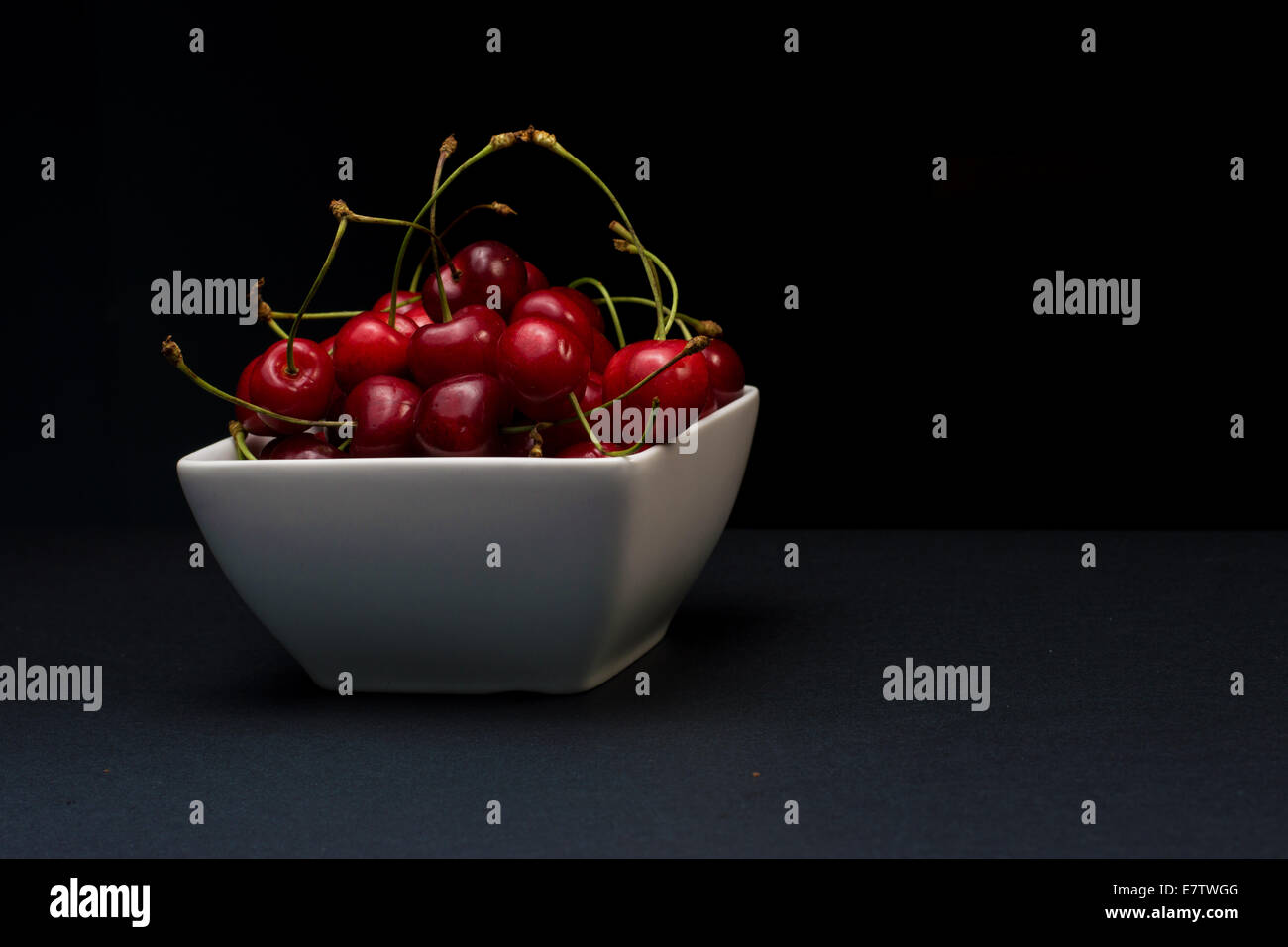 Cherries on dark background Stock Photo - Alamy