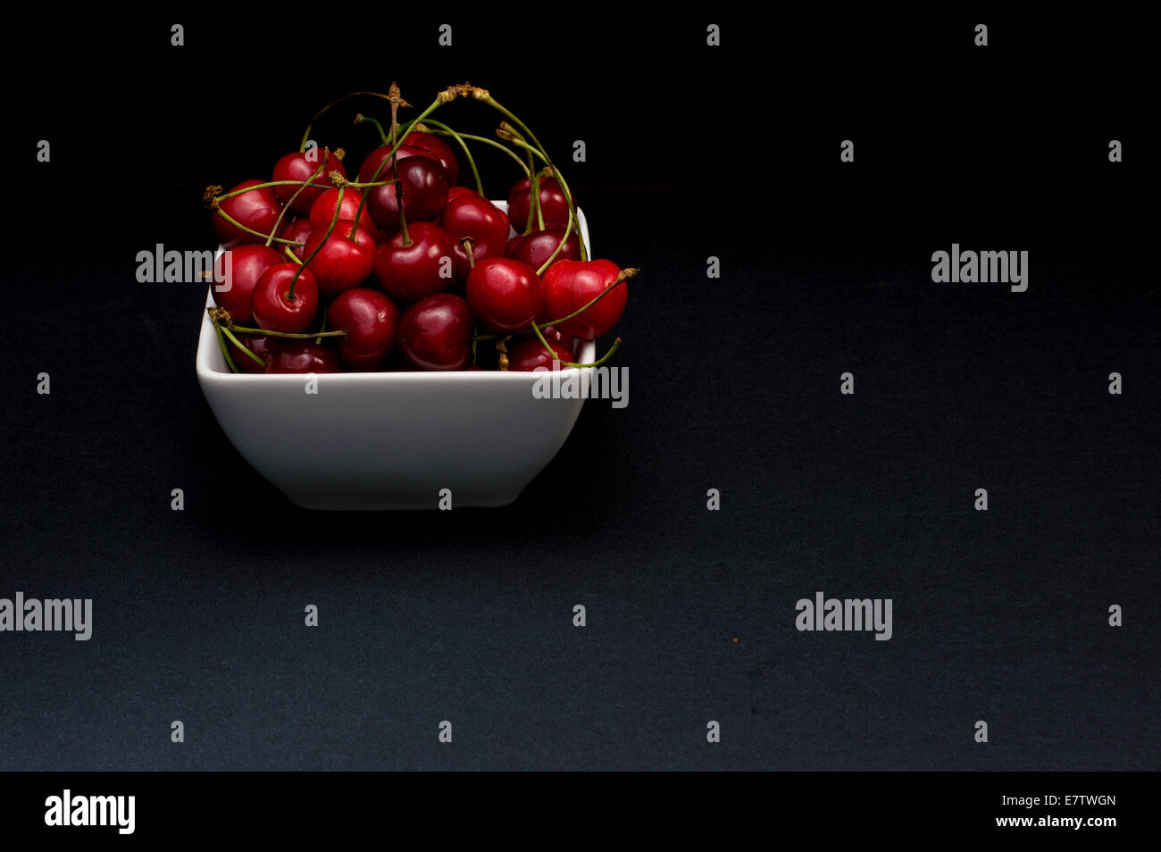 Cherries on dark background Stock Photo - Alamy