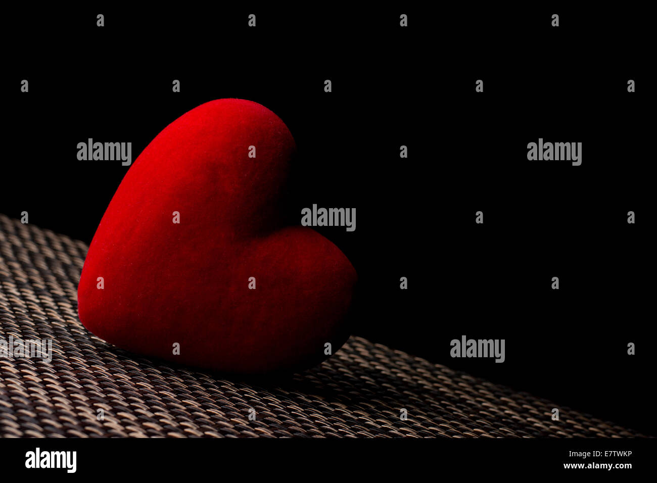 Red heart with pins on dark background Stock Photo - Alamy