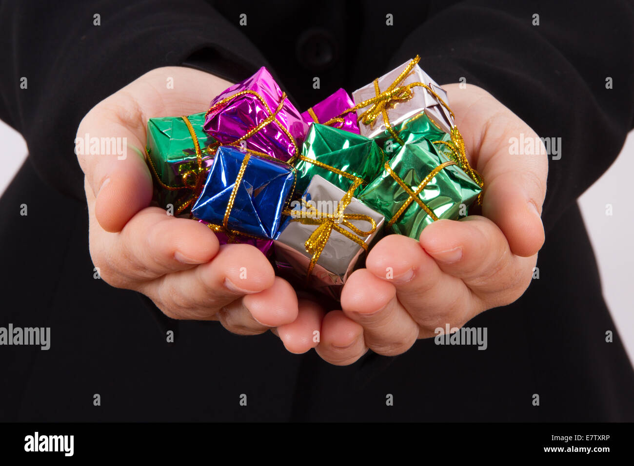 Hands extend colorful gift boxes Stock Photo - Alamy