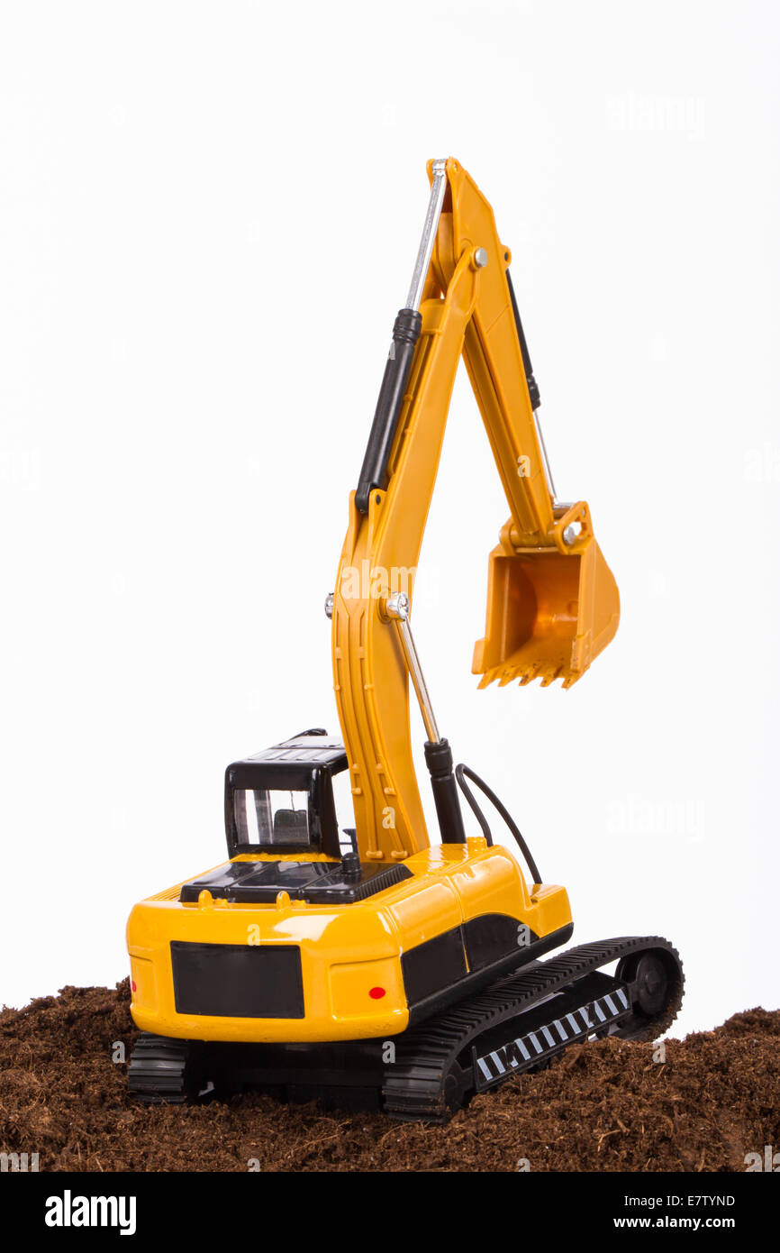 Construction machine, excavator on pile of soil digging a trench ...