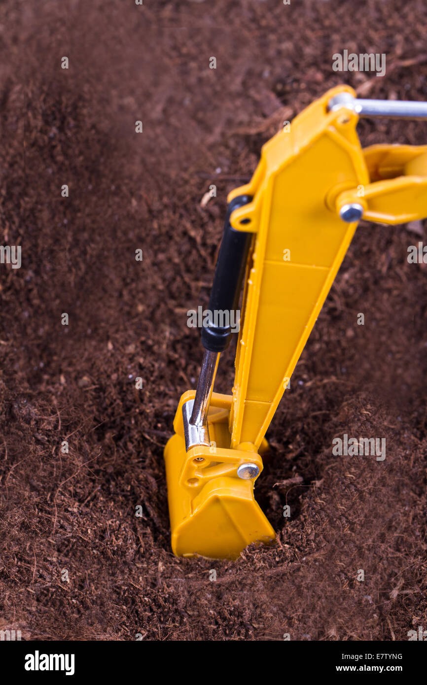 Construction machine, excavator on pile of soil digging a trench Stock ...