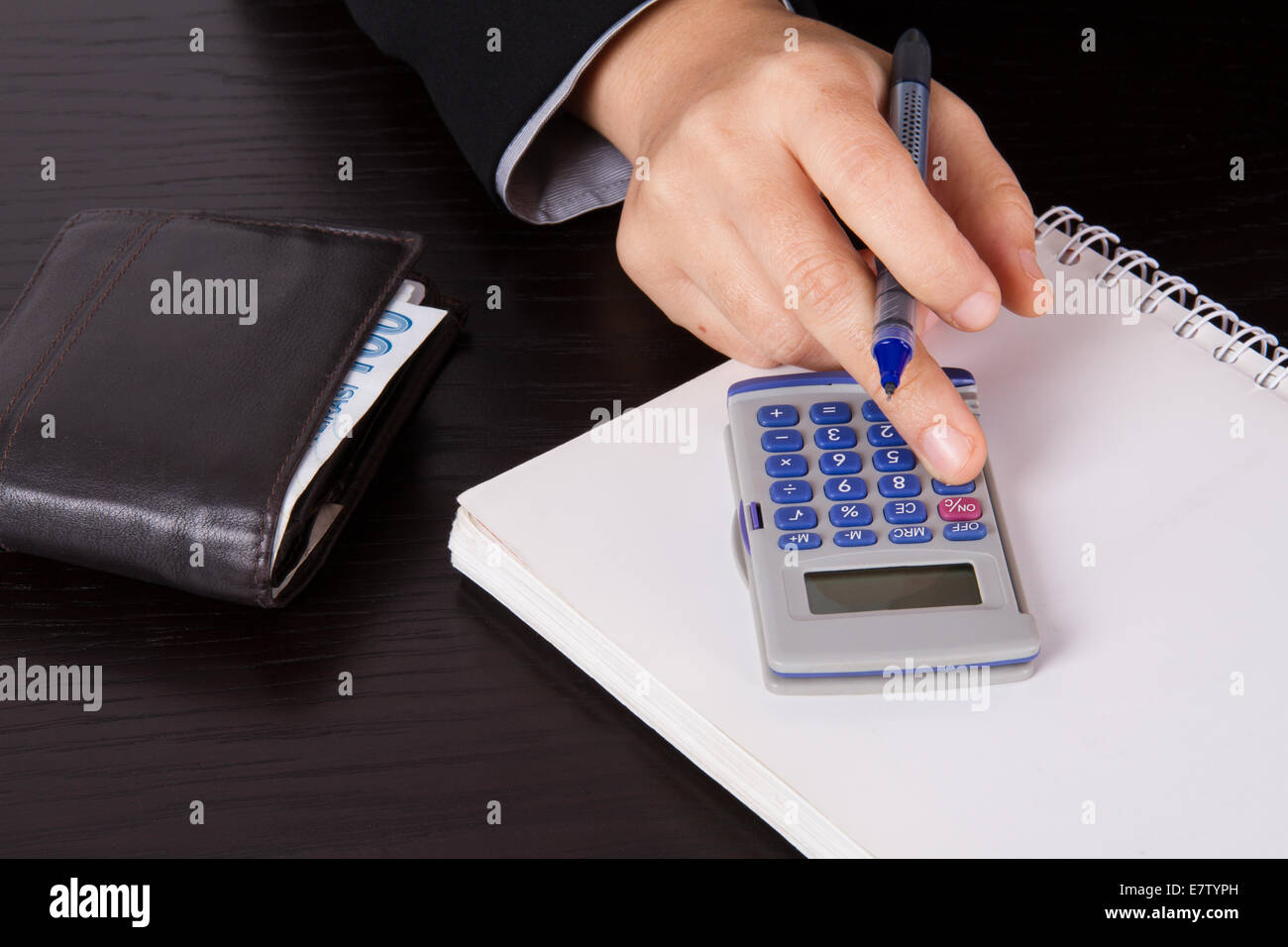 Business woman in suit calculating account on dark table Stock Photo ...