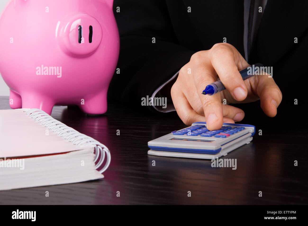 Business woman in suit calculating account on dark table Stock Photo ...