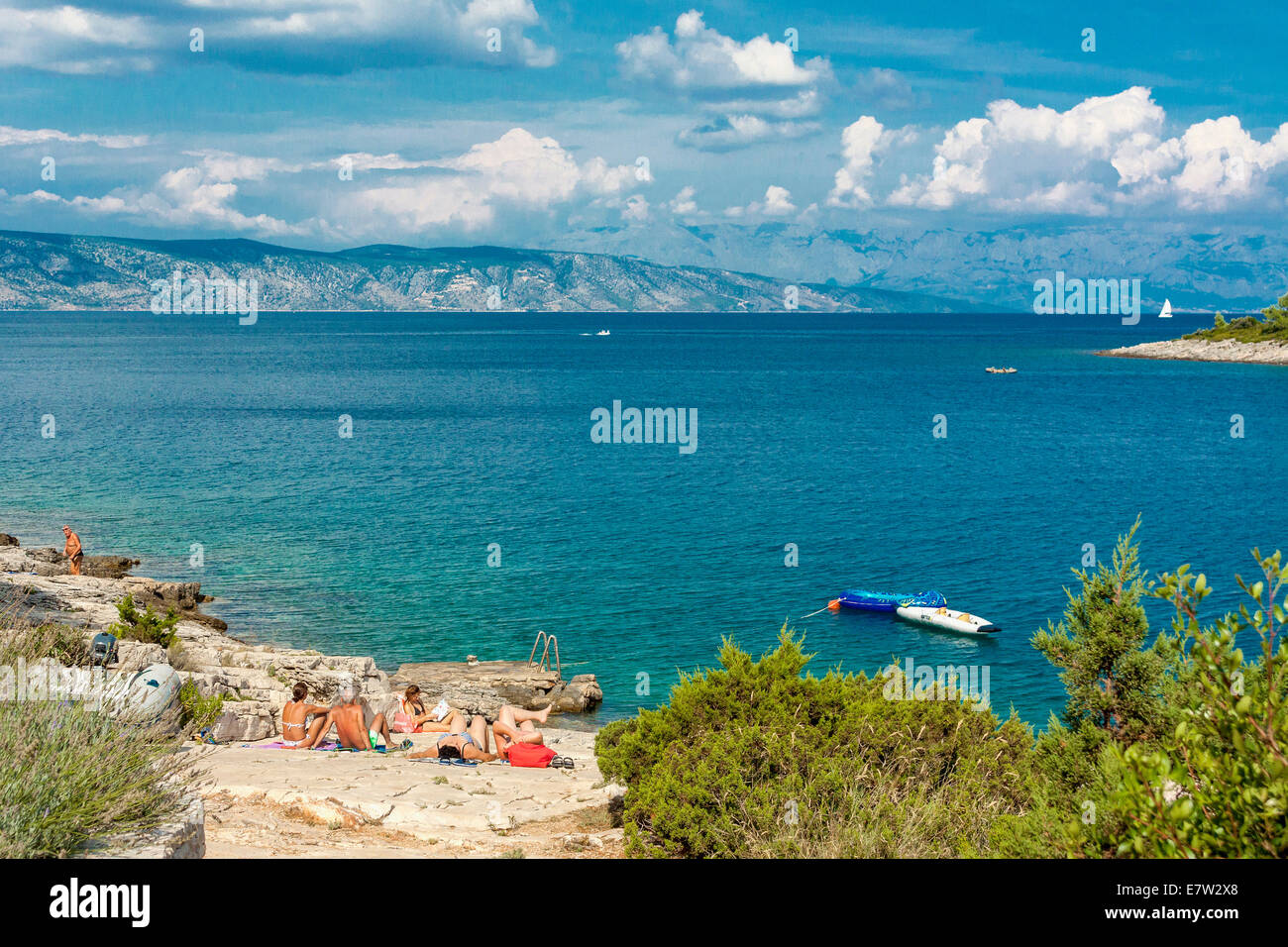 People relaxing on a beach in Rosohotnica bay in Basina village, Hvar ...