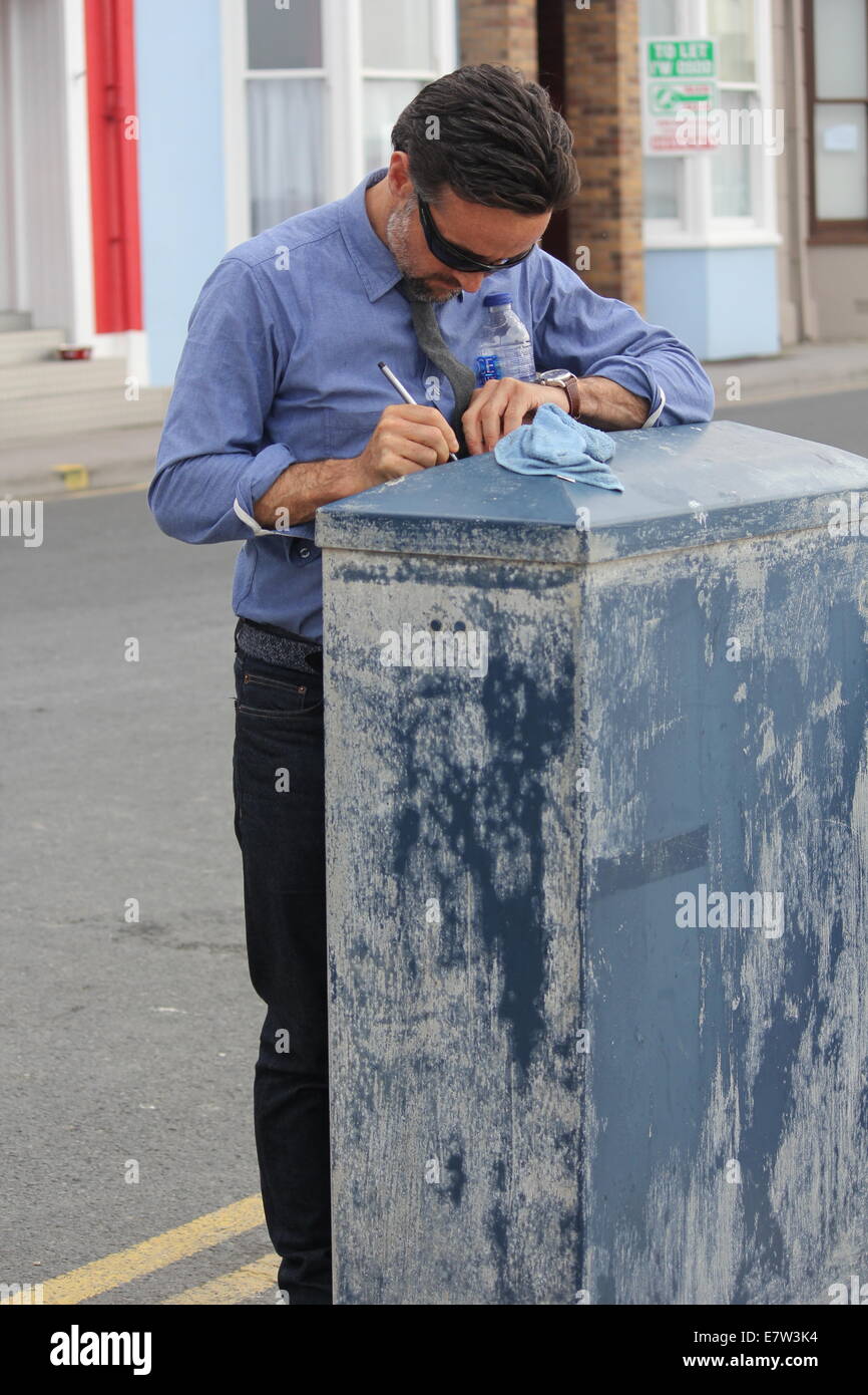 Richard Harrington "actor" signs an autograph for a fan whilst filming ...