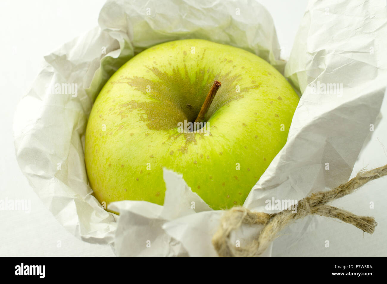Green apple in a package tied with a rope Stock Photo - Alamy