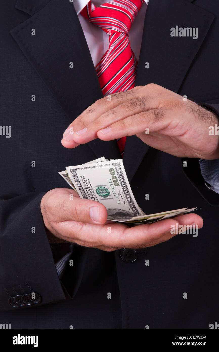 Businessman protecting, saving money between two hands Stock Photo - Alamy