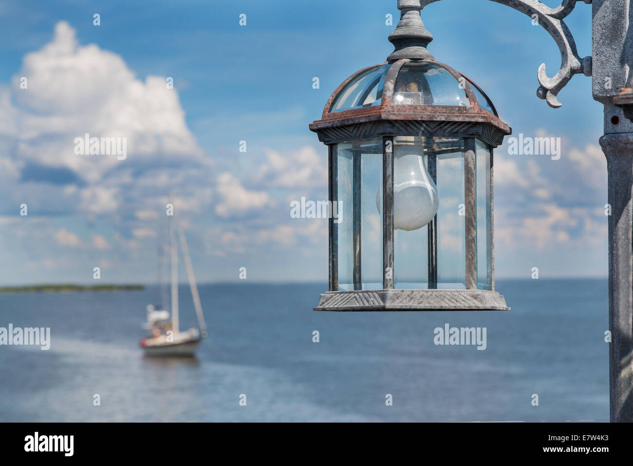 Lantern with light bulb by the ocean Stock Photo - Alamy