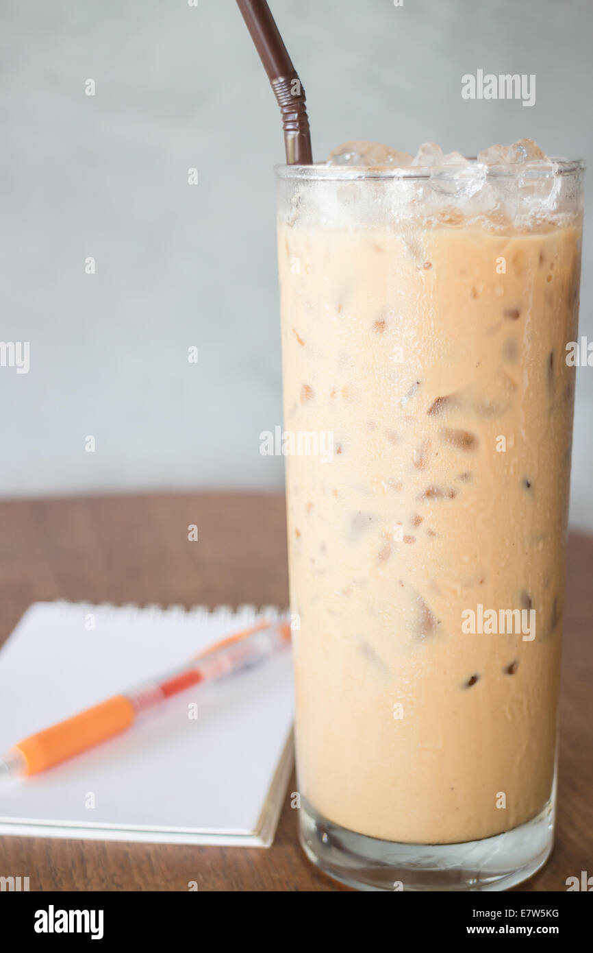 Cold milk coffee and notepaper on wooden table, stock photo Stock Photo ...