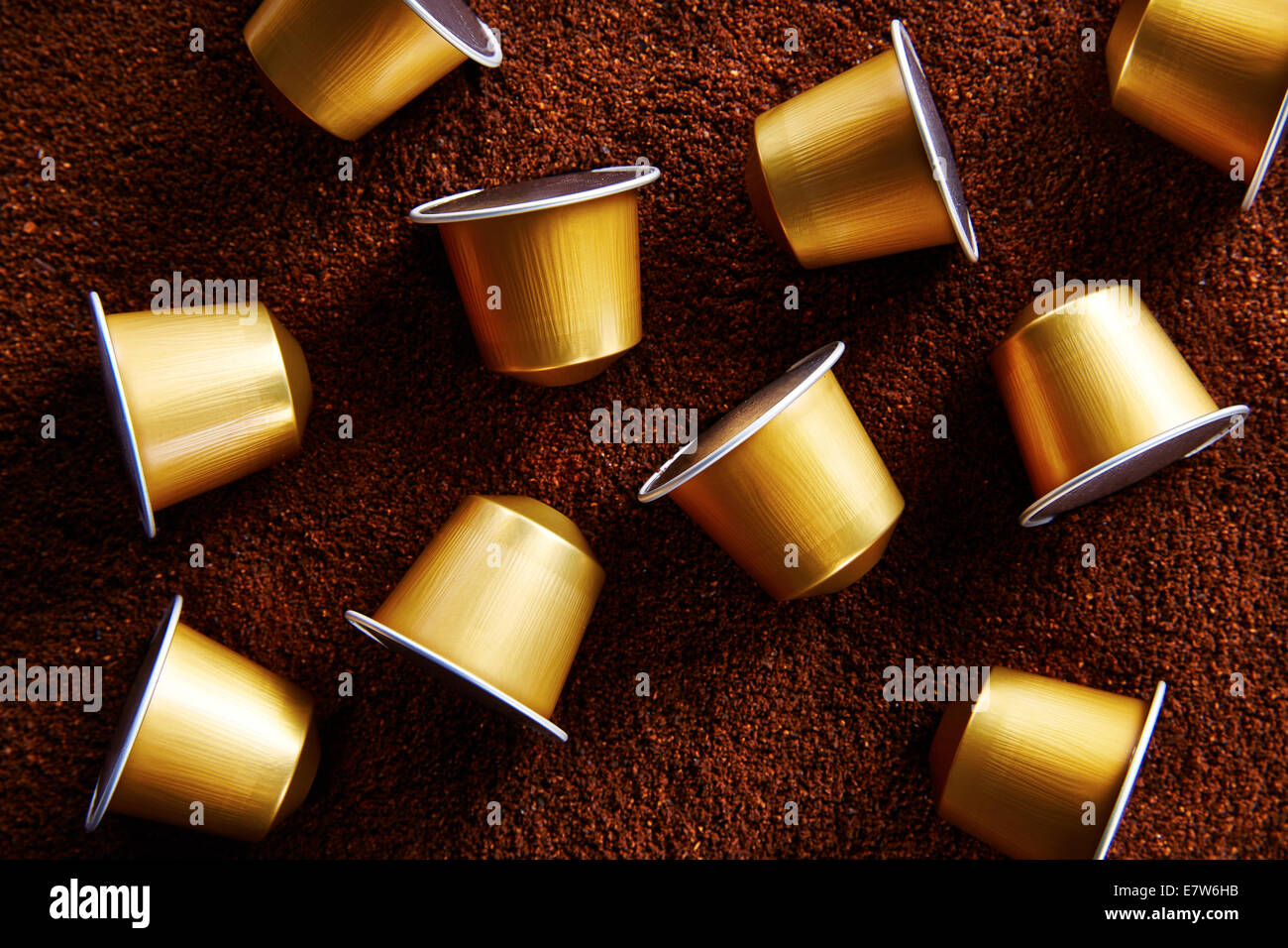 Fancy gold coffee capsules on coffee background Stock Photo - Alamy