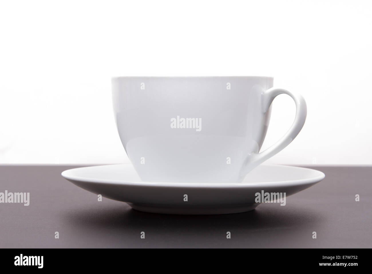 Black coffee in white ceramic cup, side view on wooden table, isolated ...