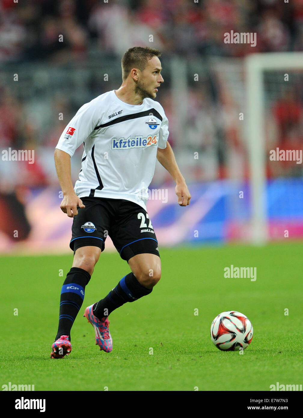 Munich, Germany. 23rd Sep, 2014. Paderborn's Michael Heinloth controls ...