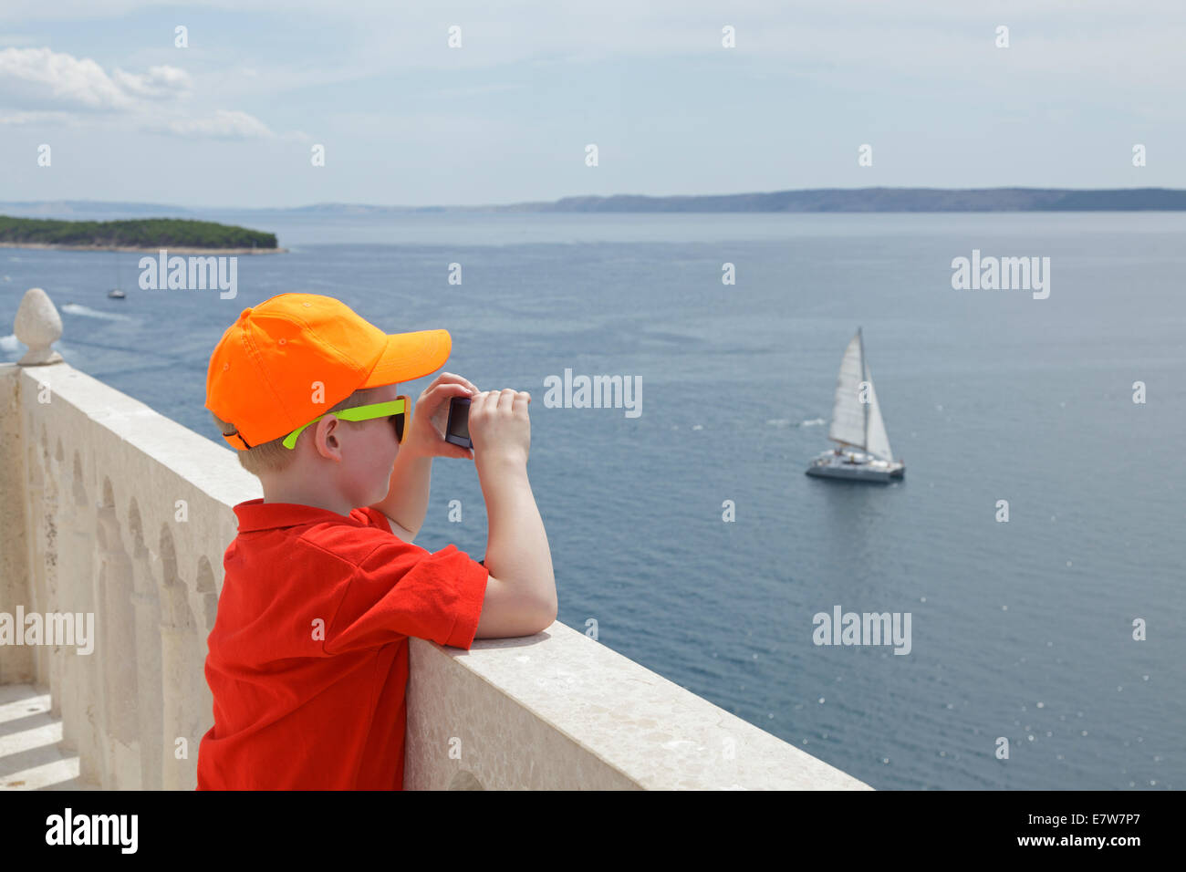 young boy taking picture from St Mary´s church bell tower, Rab Town ...