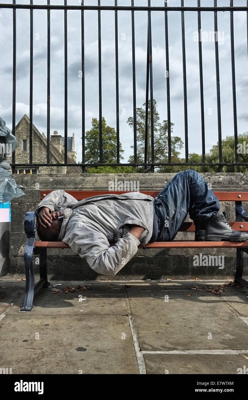 Homeless drug addict asleep on park bench Stock Photo - Alamy