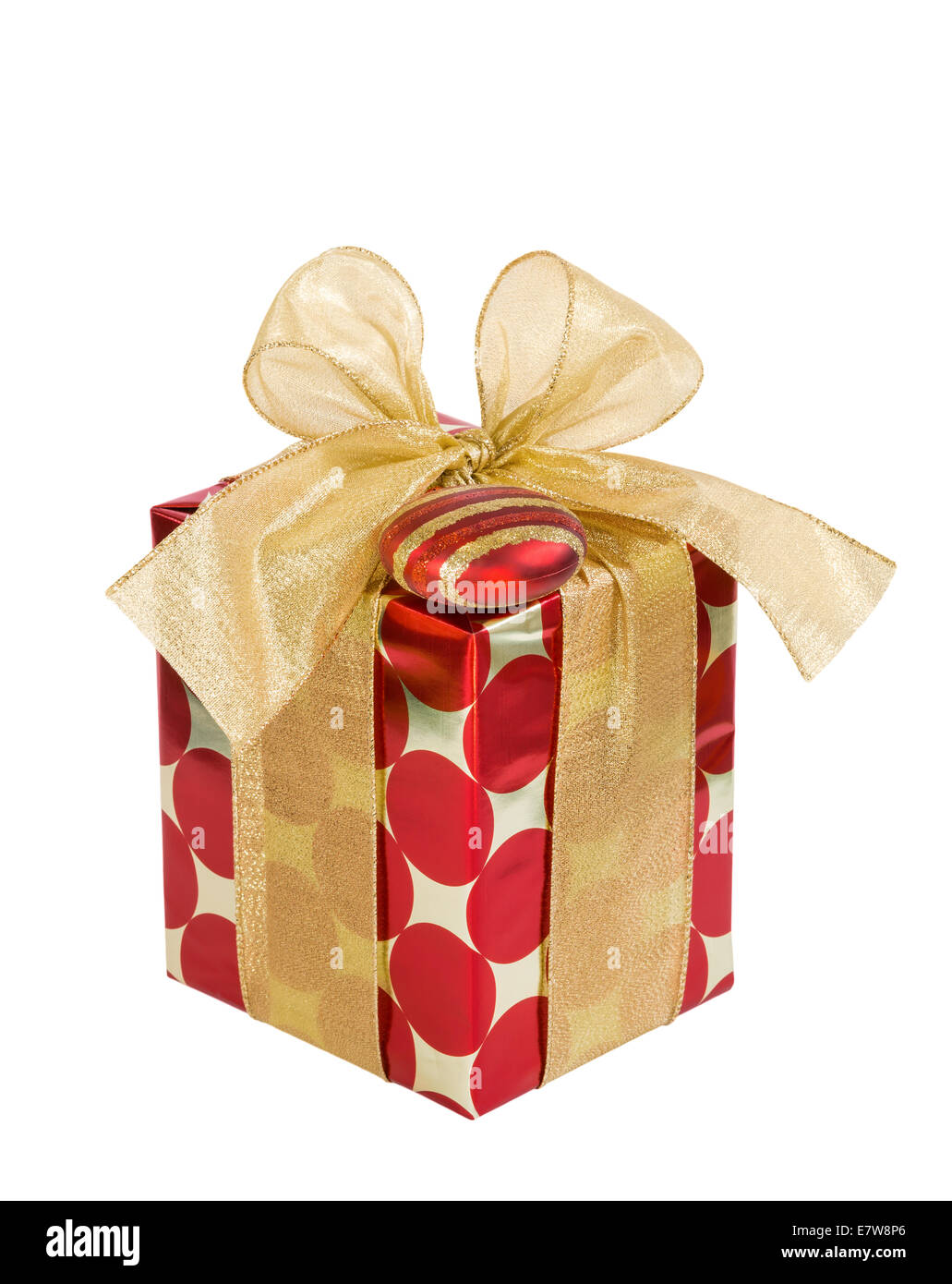 Red and golden gift wrapped present with a bow and Christmas ornament ...