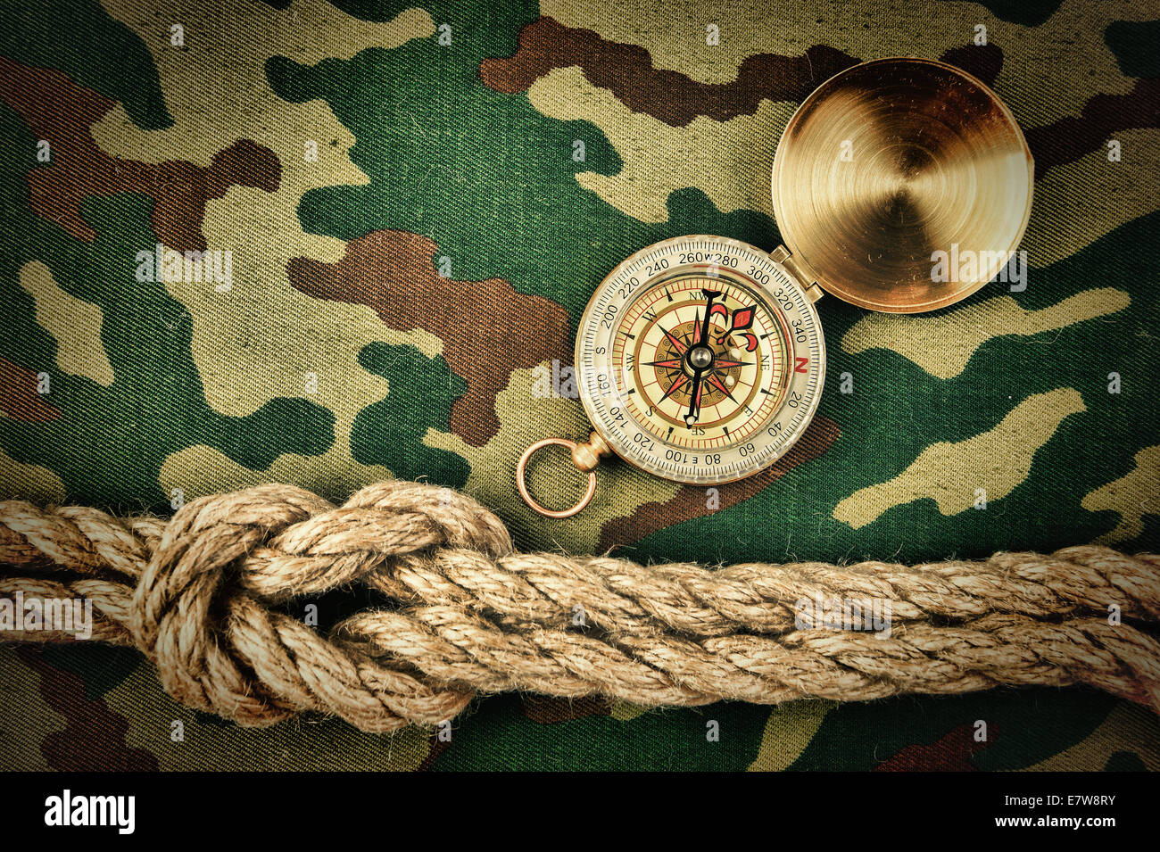 Compass and rope on a camouflage background Stock Photo - Alamy