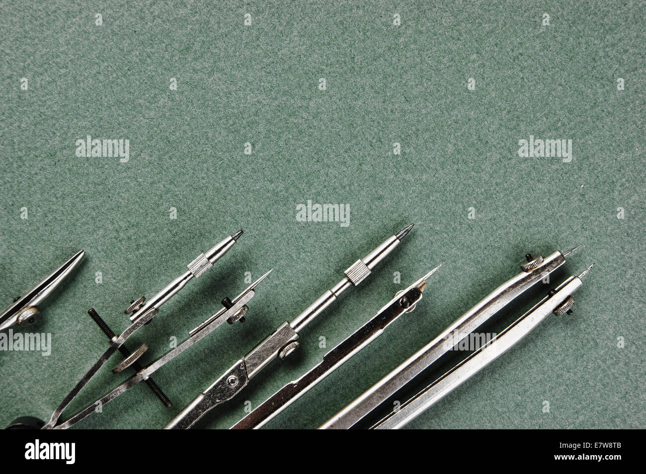 Old drawing tools on a green background Stock Photo - Alamy