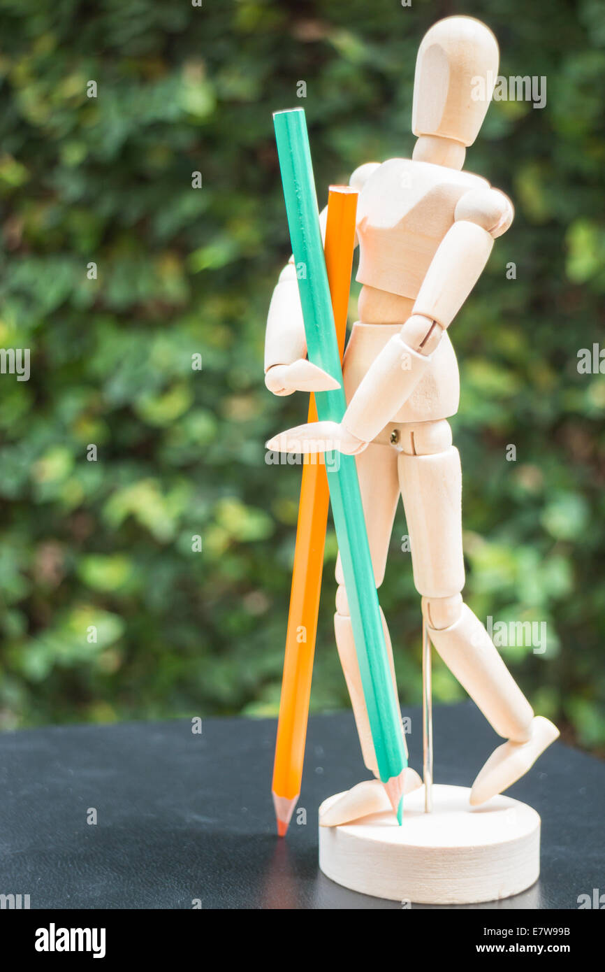 Wooden artist manikin standing with colour pencil, stock photo Stock ...