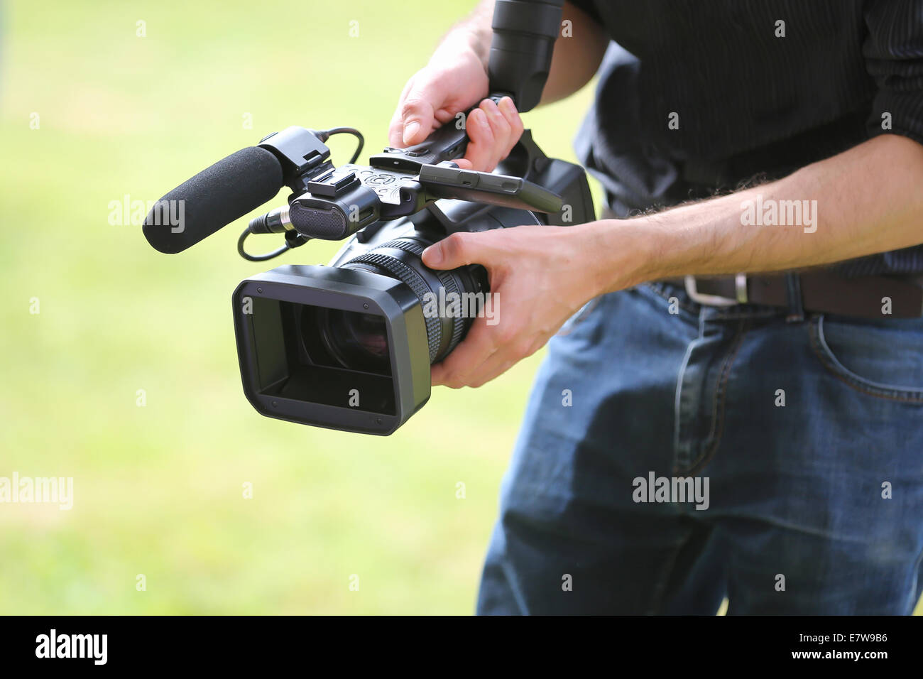 Video camera man with camera on green background Stock Photo - Alamy