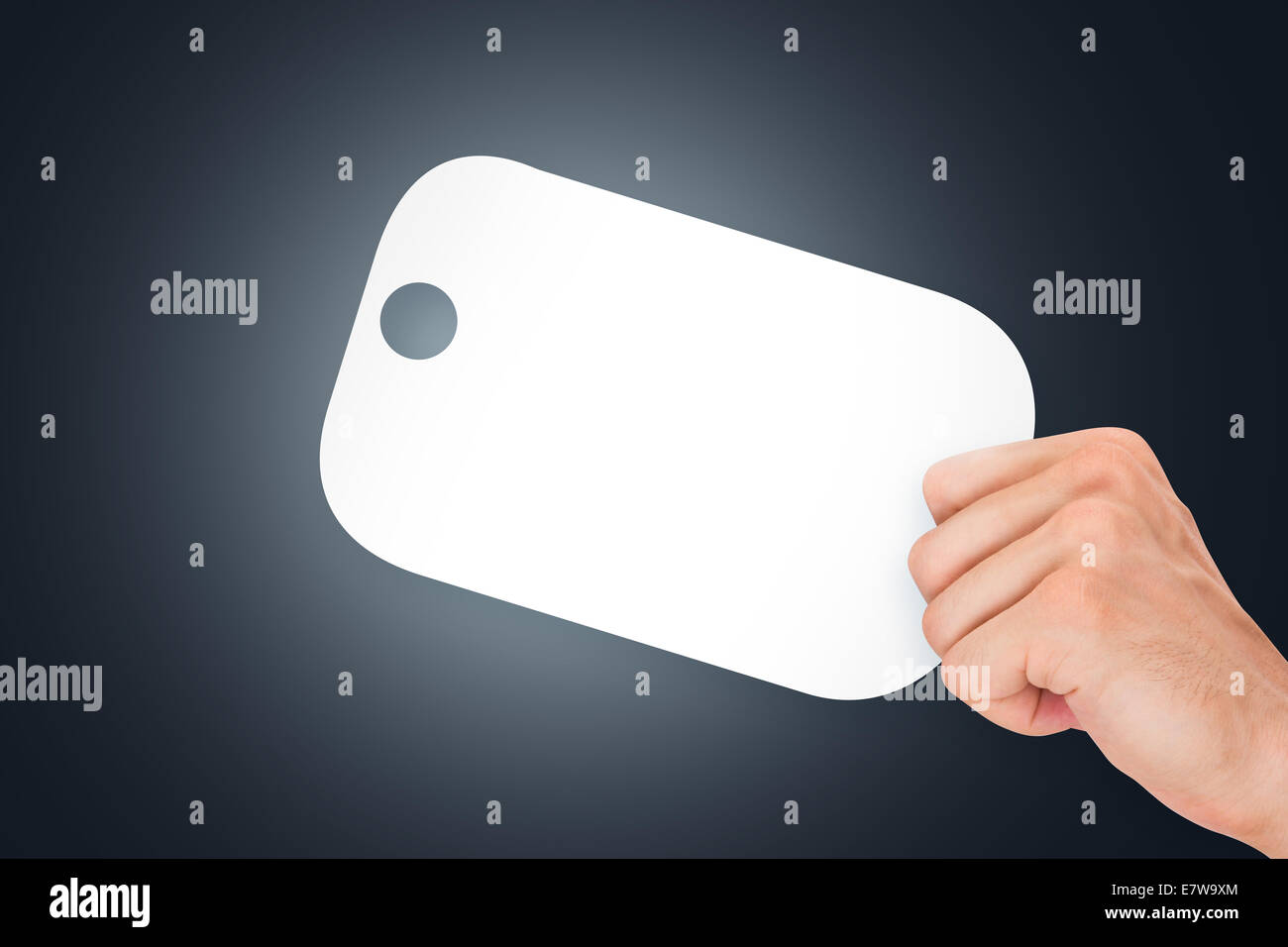 Hand holding white, empty, blank shopping label cardboard on dark ...