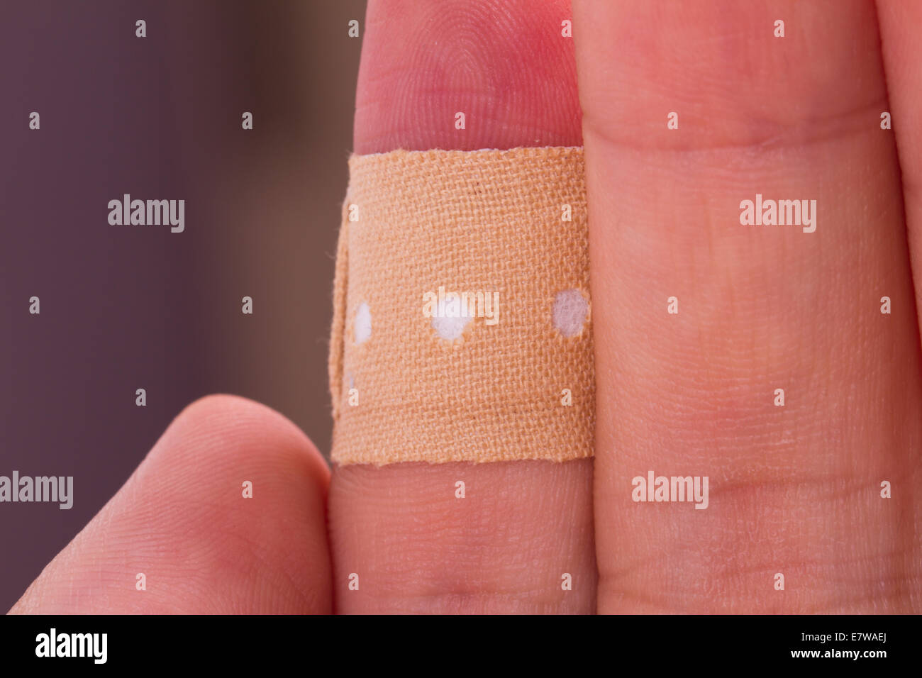 Close up view of adhesive bandage, plaster on index finger, isolated on ...