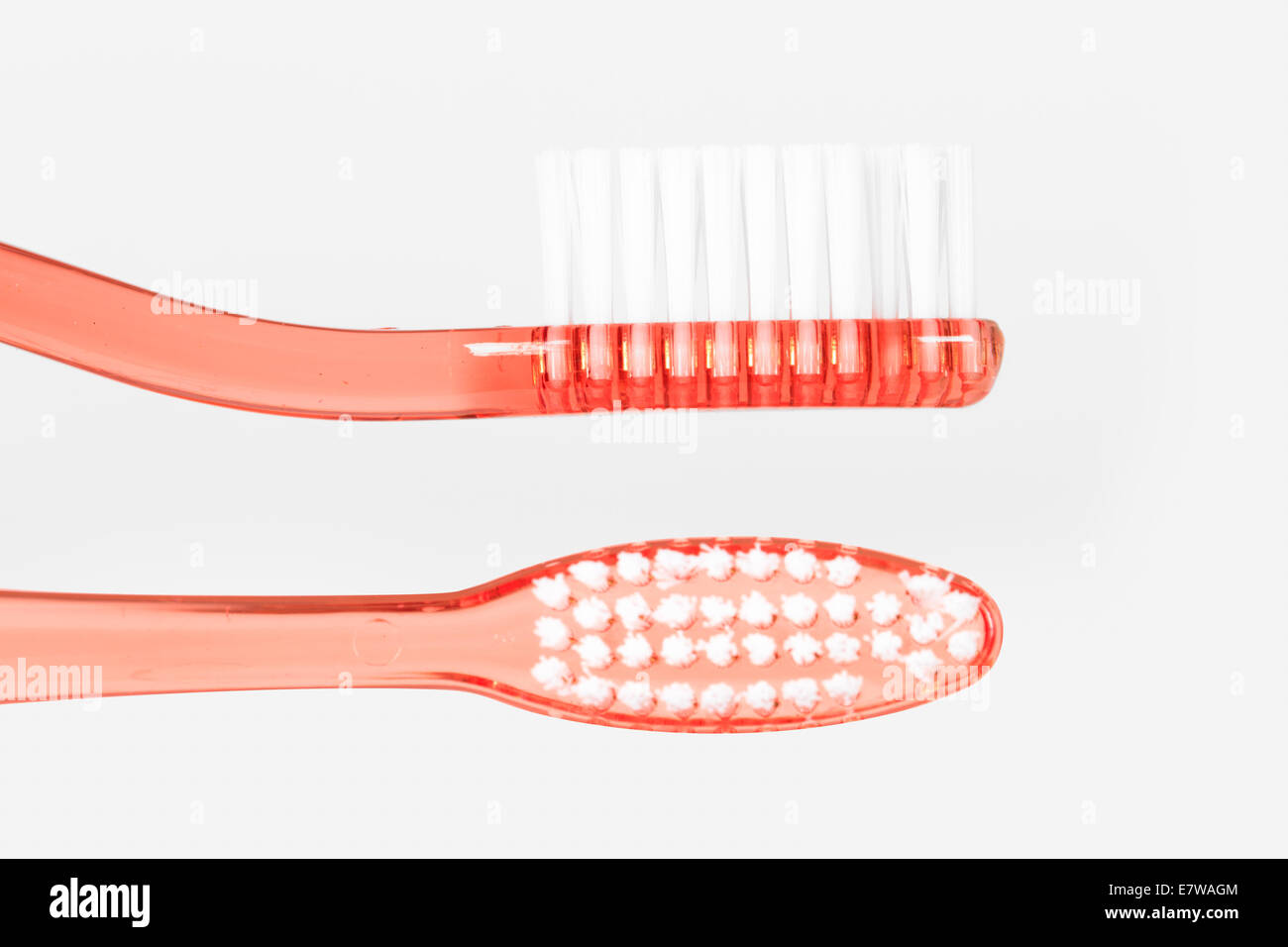 Top and side view of toothbrush with red plastic body, isolated on ...